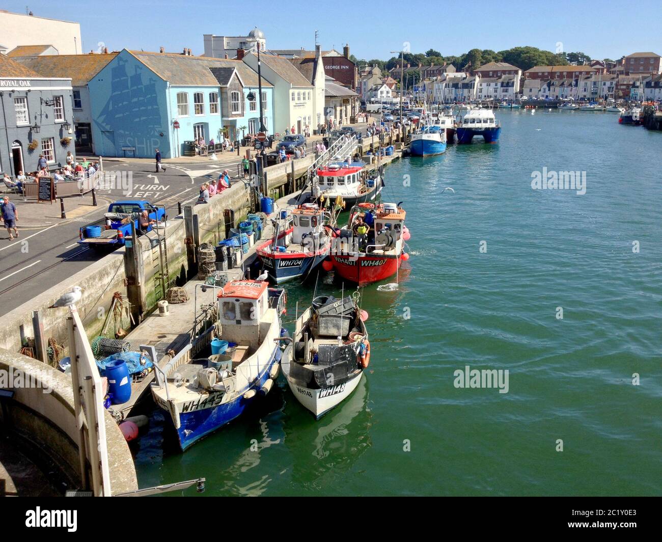 The picturesque fishing harbour and beach seafront of Weymouth. The ...