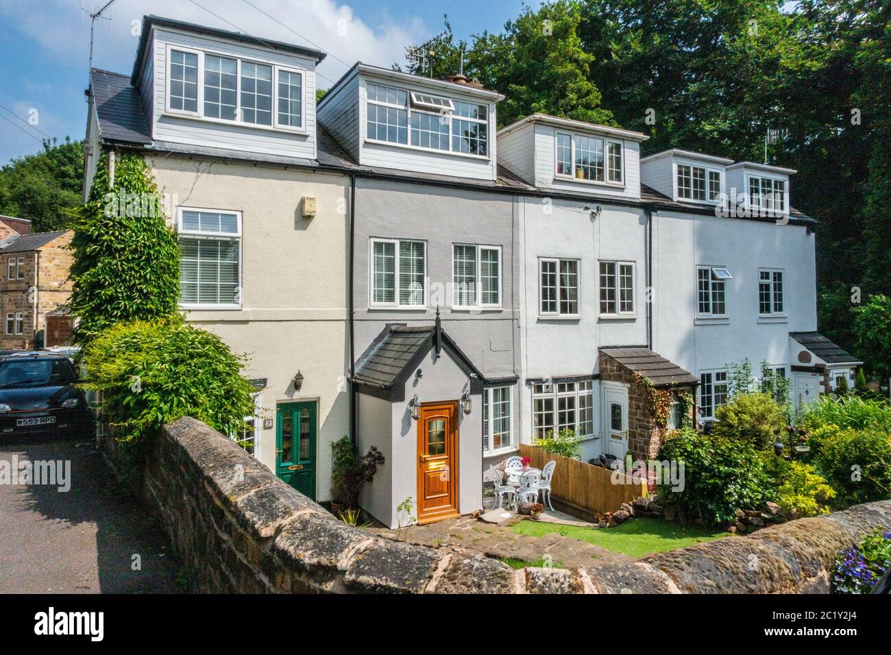 Row of pretty village cottages with dormer window roofed structures ...