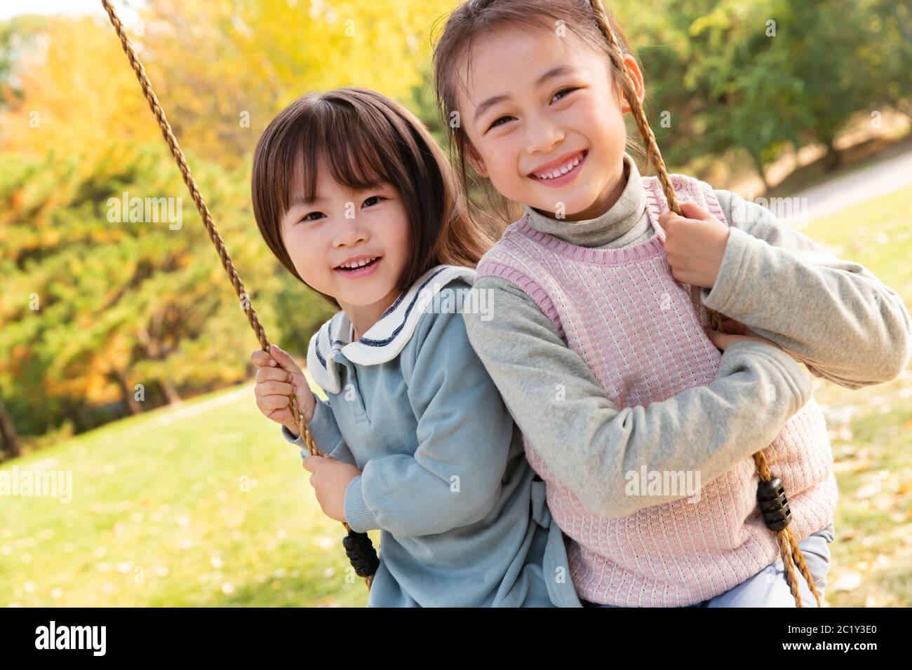 Two girls swing hi-res stock photography and images - Alamy