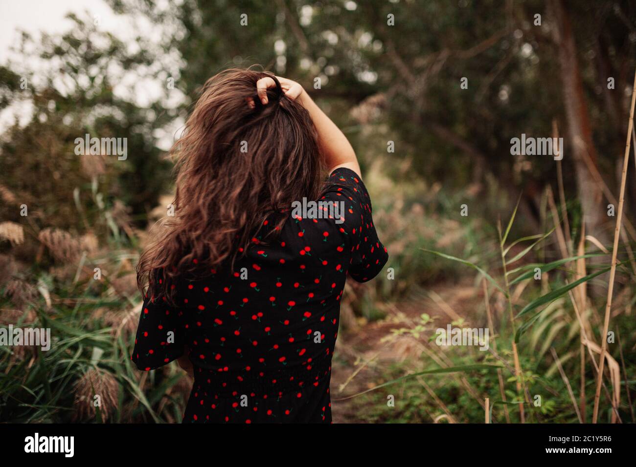 Back view of two young women walking through the field Stock Photo - Alamy