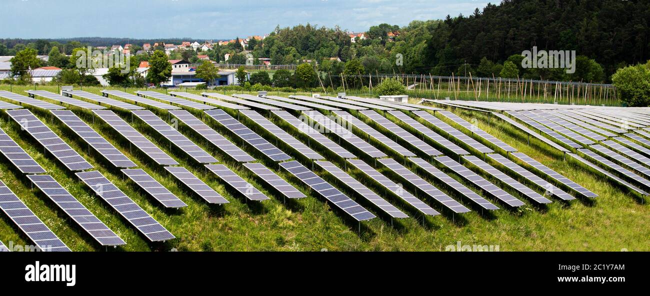 Small Photovoltaic Solar Farm with black panels on a little hill with a ...