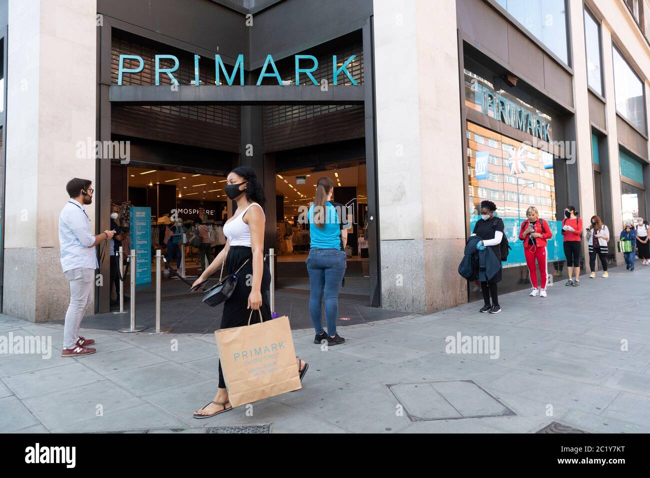 London, UK. 15th June, 2020. Shoppers queue outside Primark store in ...