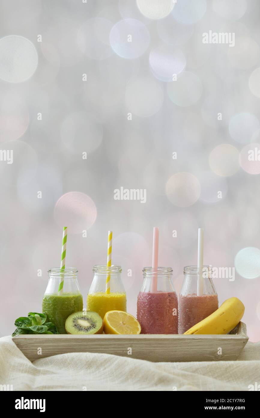 colorful fruit smoothies in a row with fresh fruits Stock Photo - Alamy