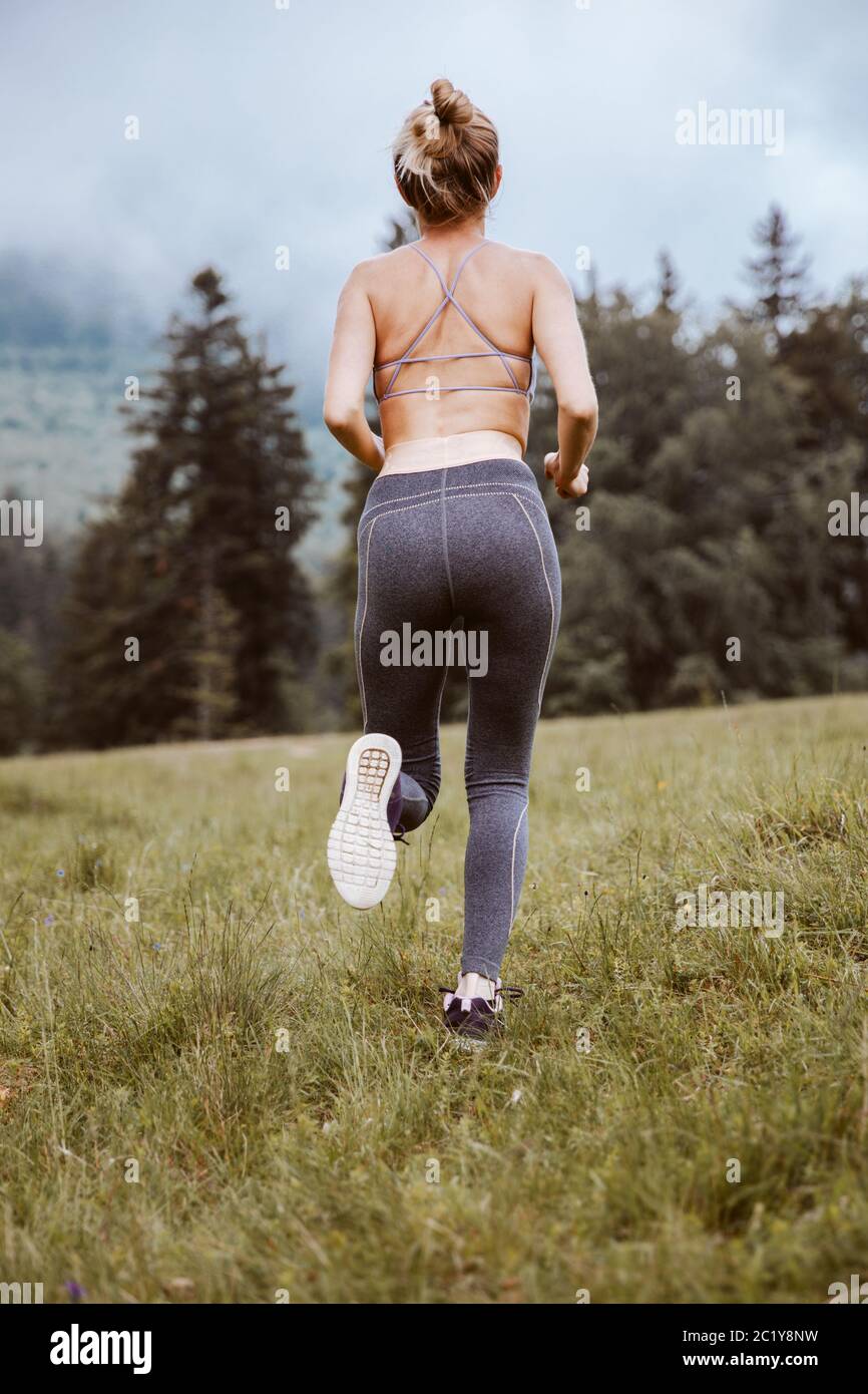 Woman running. Female runner jogging, training for marathon. summer ...