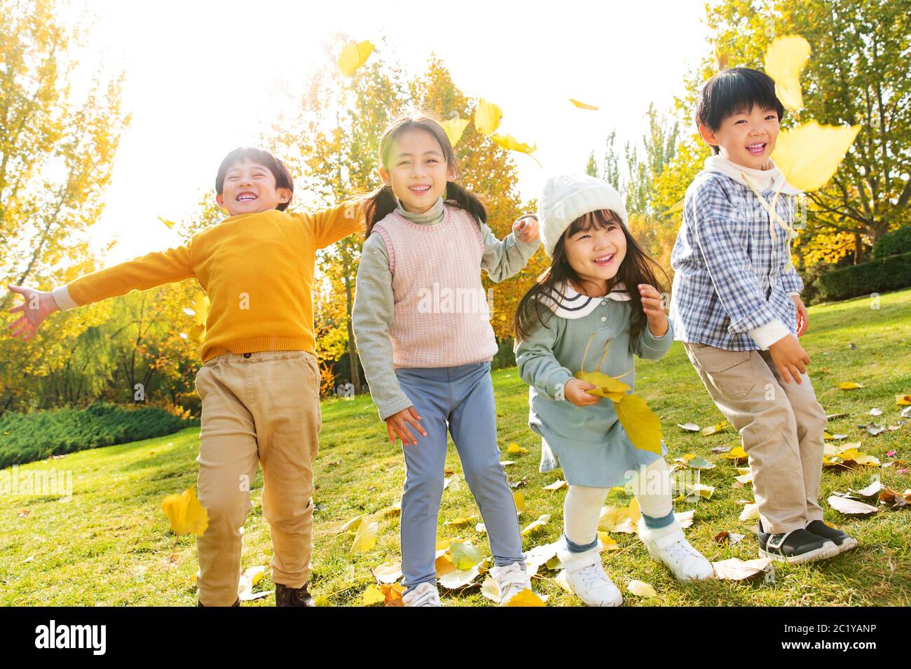 Happy children playing in the park the leaves Stock Photo - Alamy