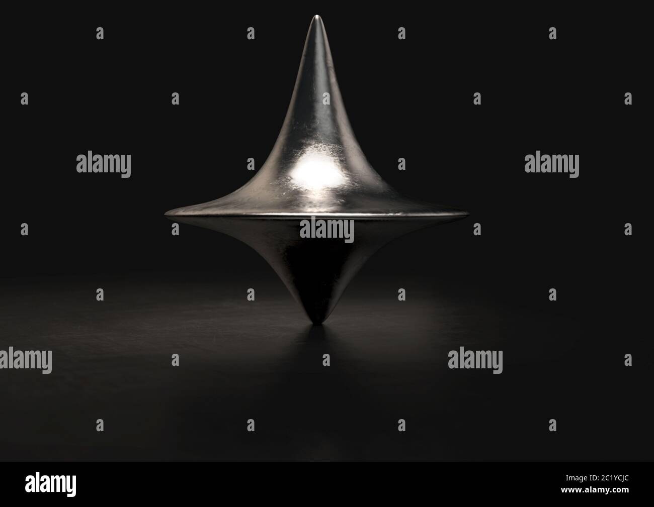 A slightly scratched die-cast lead spinning top in an upright position ...