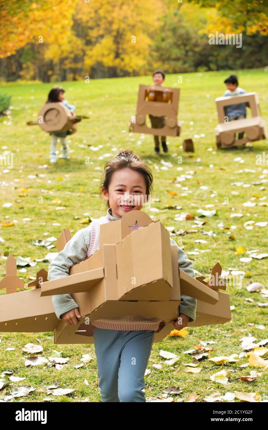 Happy children's play to fly Stock Photo - Alamy