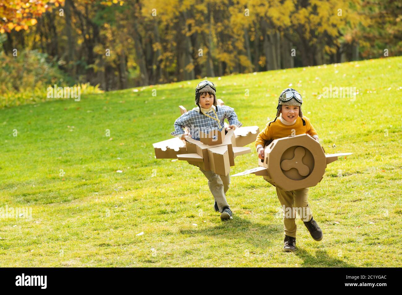 Two boys play to fly Stock Photo - Alamy
