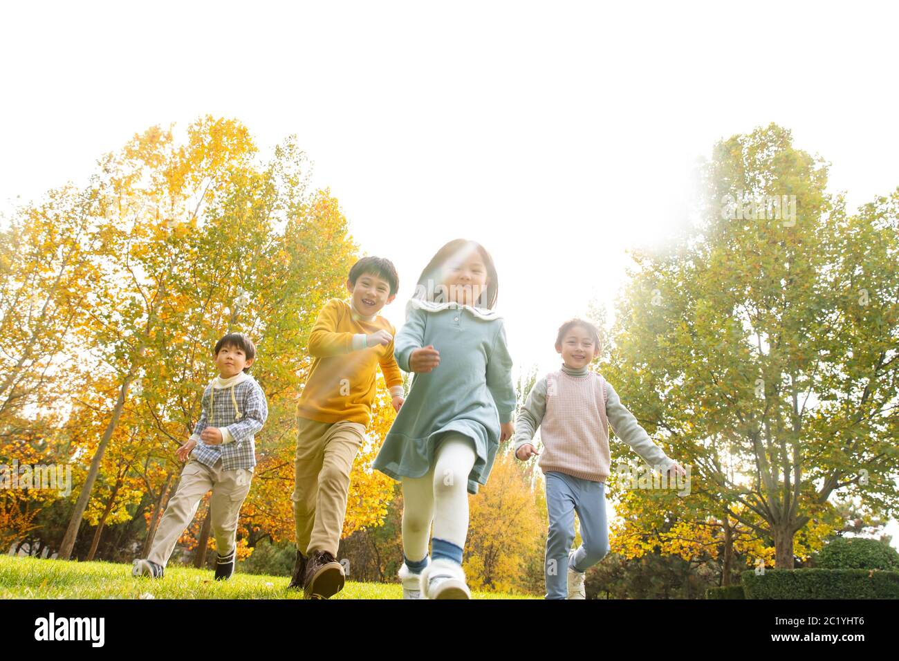 Happy children run to play in the park Stock Photo - Alamy
