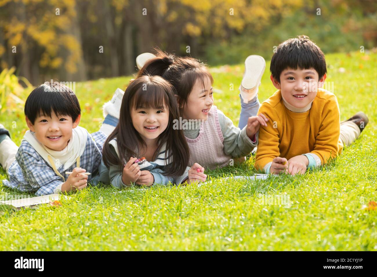 Lovely children playing on the grass Stock Photo - Alamy