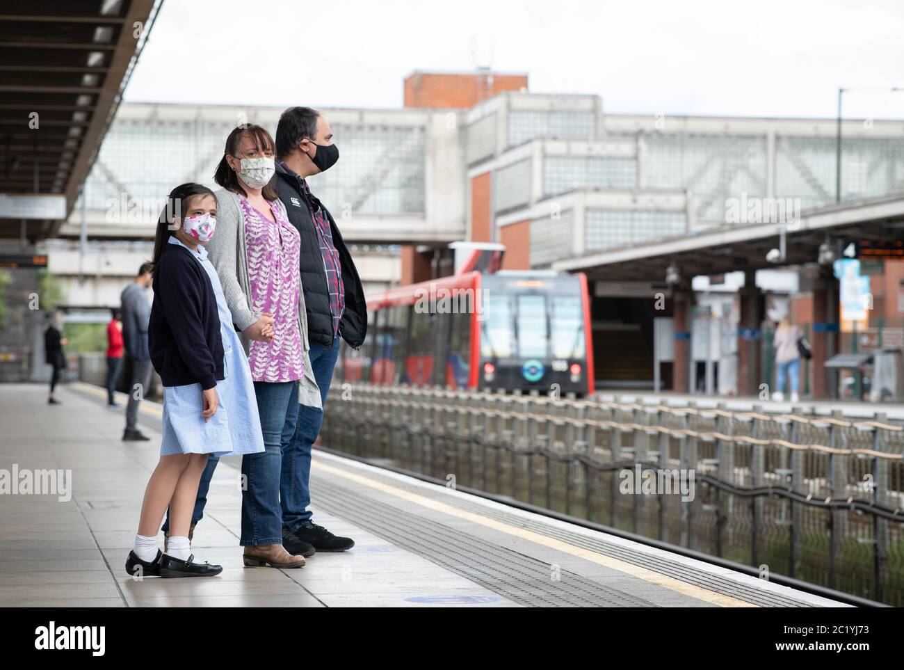 Children wearing facemasks on public transport. West Ham, Jubilee line ...