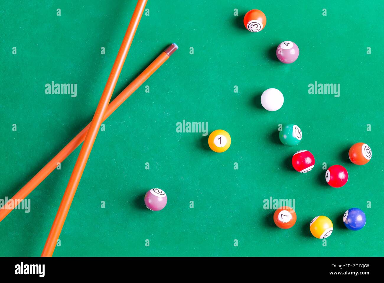 Billiard colorful balls with wooden cue on green table. Snooker, Pool ...