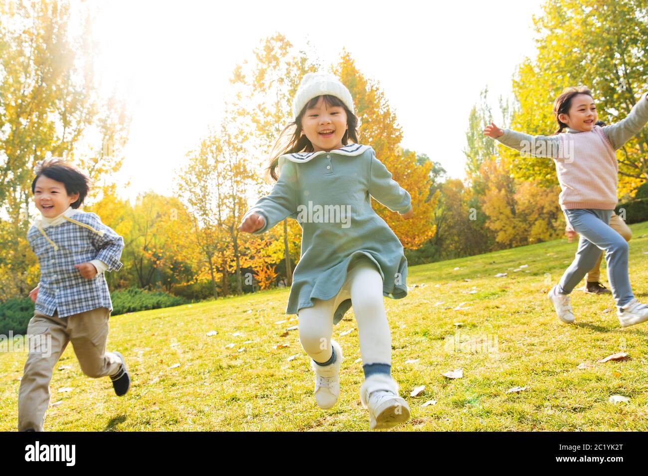 Happy children run on the grass Stock Photo - Alamy