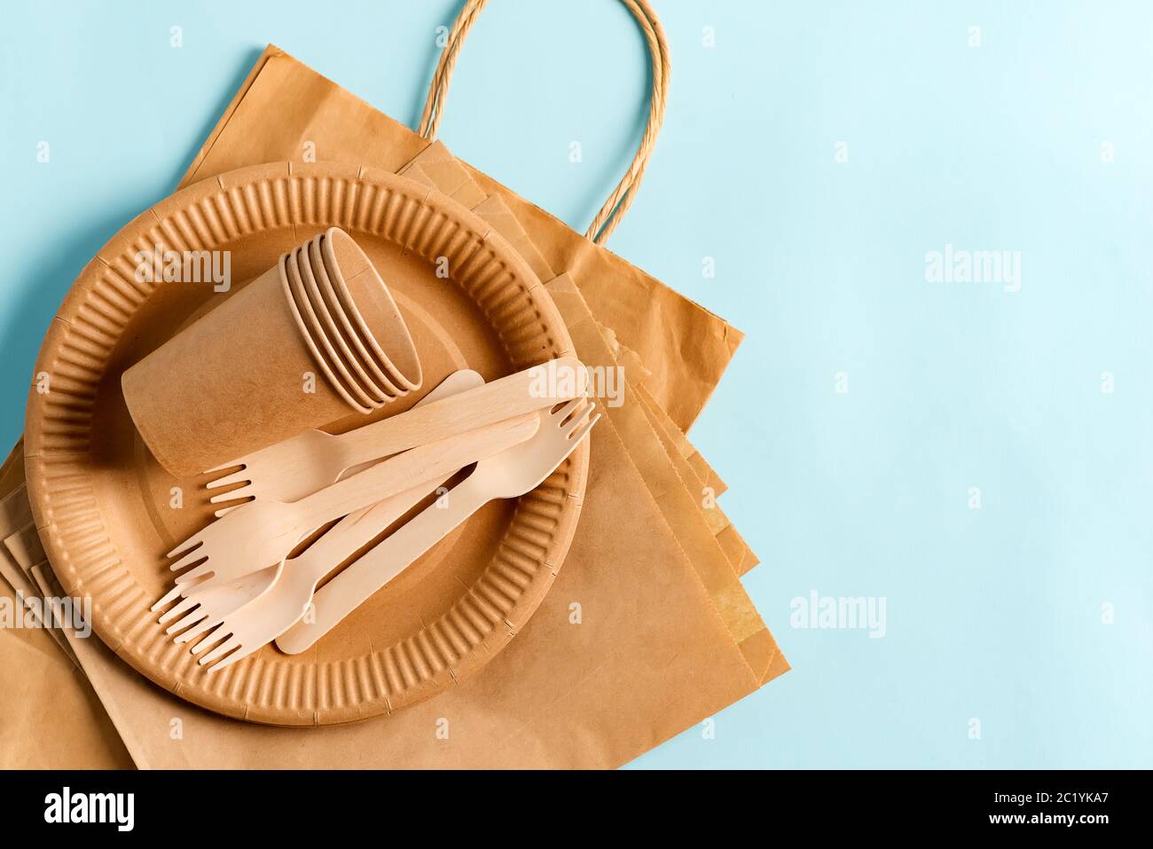 Eco friendly zero waste disposable set of dishware and paper bags on a ...