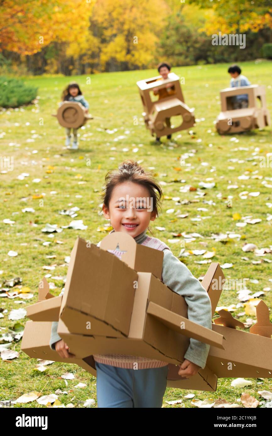 Happy children's play to fly Stock Photo - Alamy