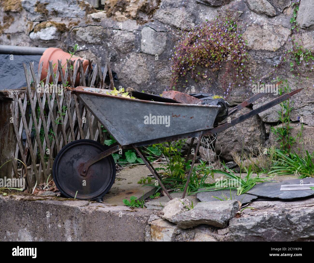 Broken wheelbarrow hi-res stock photography and images - Alamy