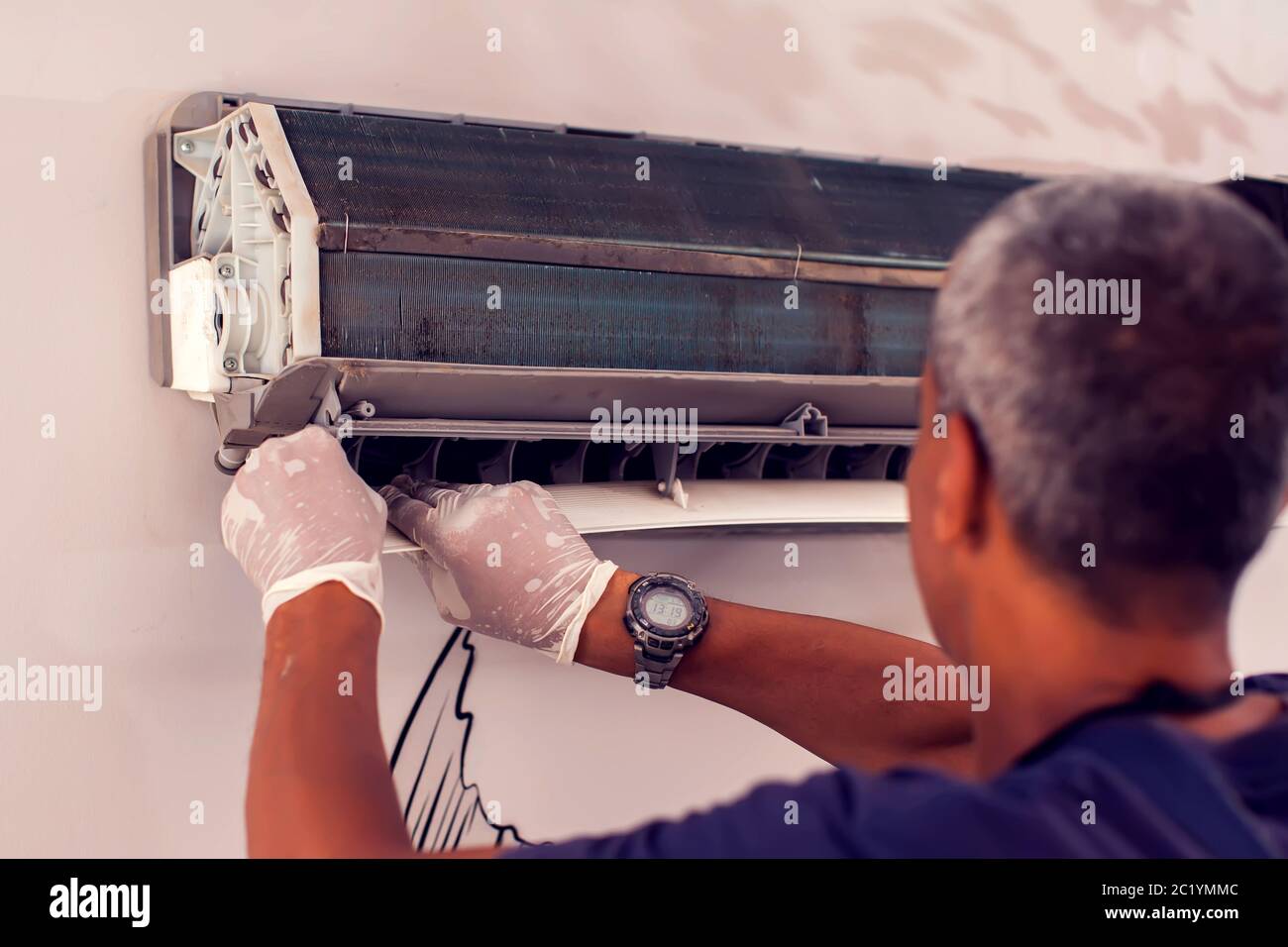 Man worker doing professional cleaning of air conditioning Stock Photo ...