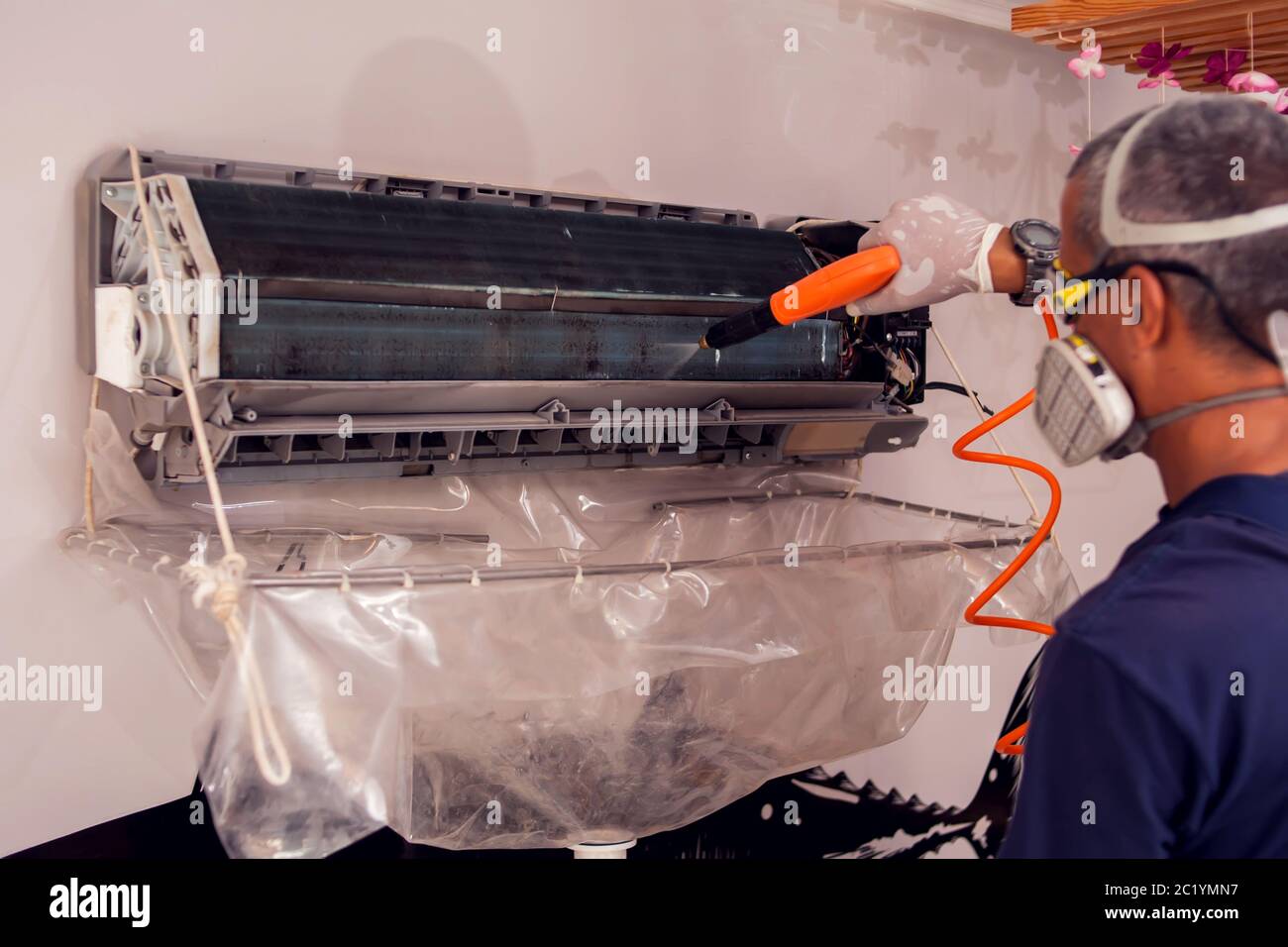 Man worker doing professional cleaning of air conditioning Stock Photo ...