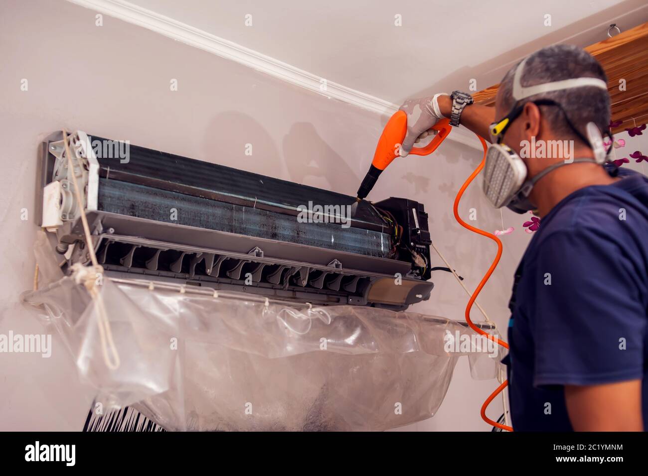 Man worker doing professional cleaning of air conditioning Stock Photo ...