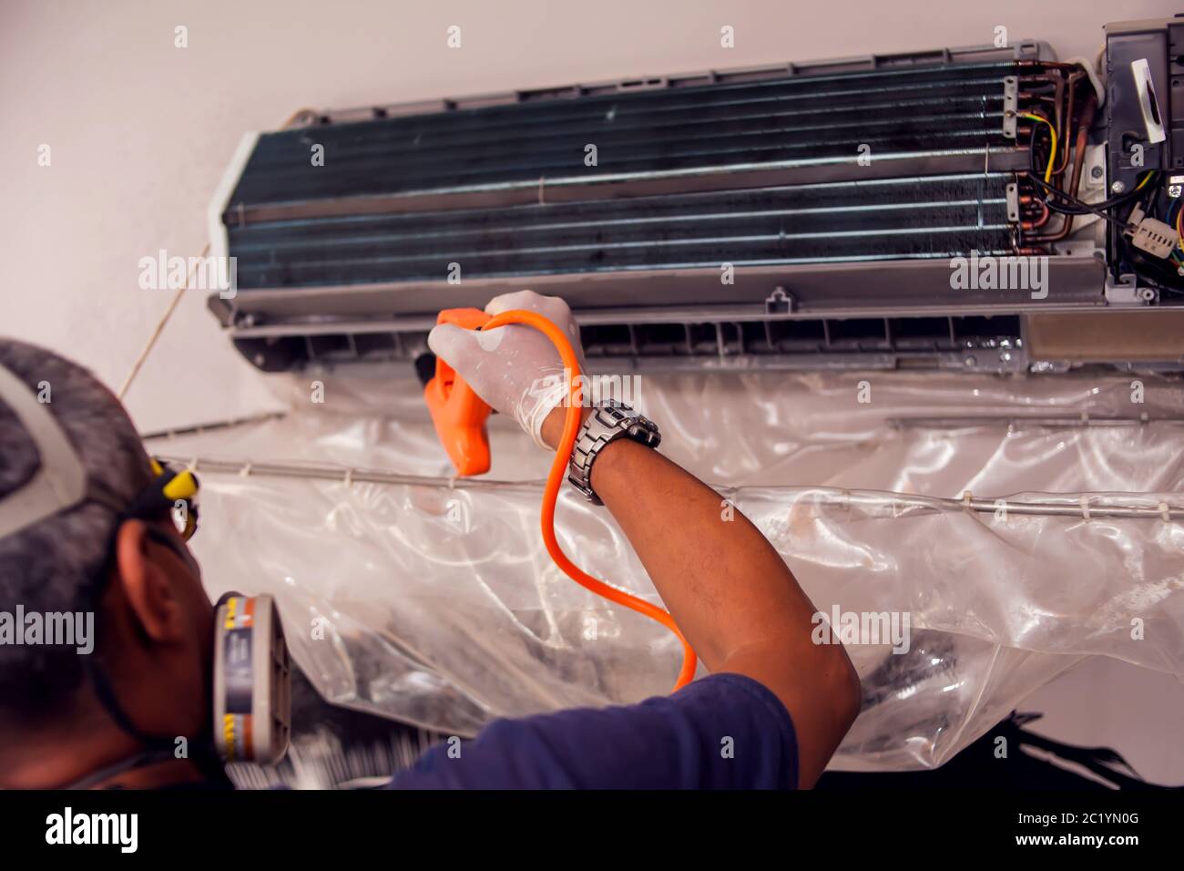 Man worker doing professional cleaning of air conditioning Stock Photo ...