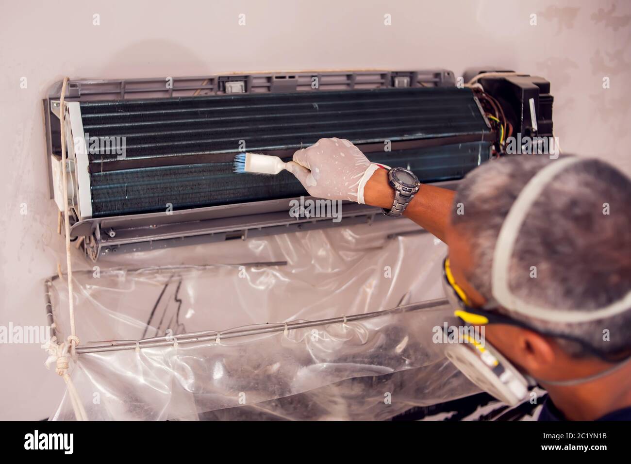 Man worker doing professional cleaning of air conditioning Stock Photo ...