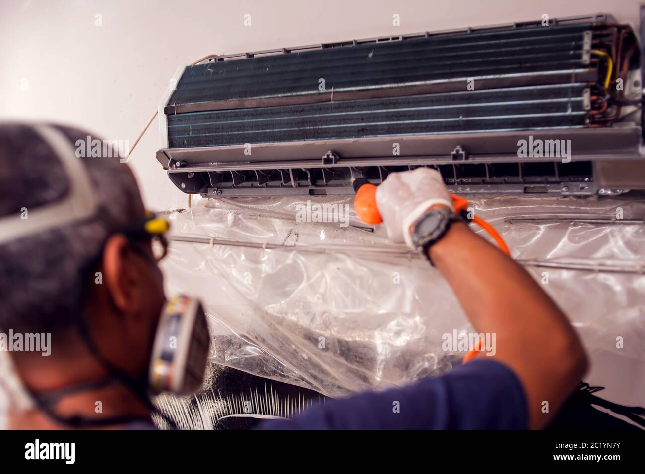 Man worker doing professional cleaning of air conditioning Stock Photo ...