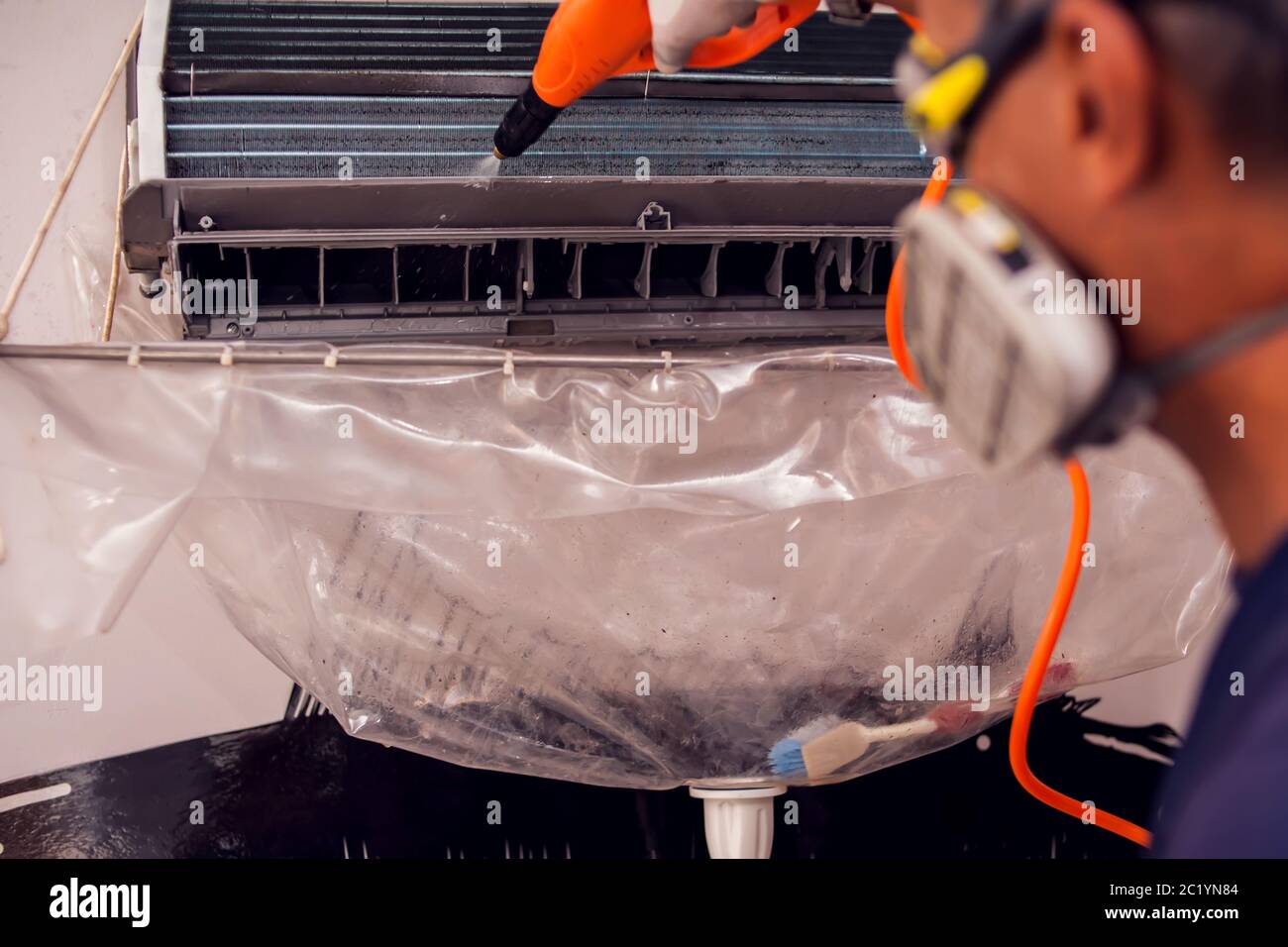 Man worker doing professional cleaning of air conditioning Stock Photo ...