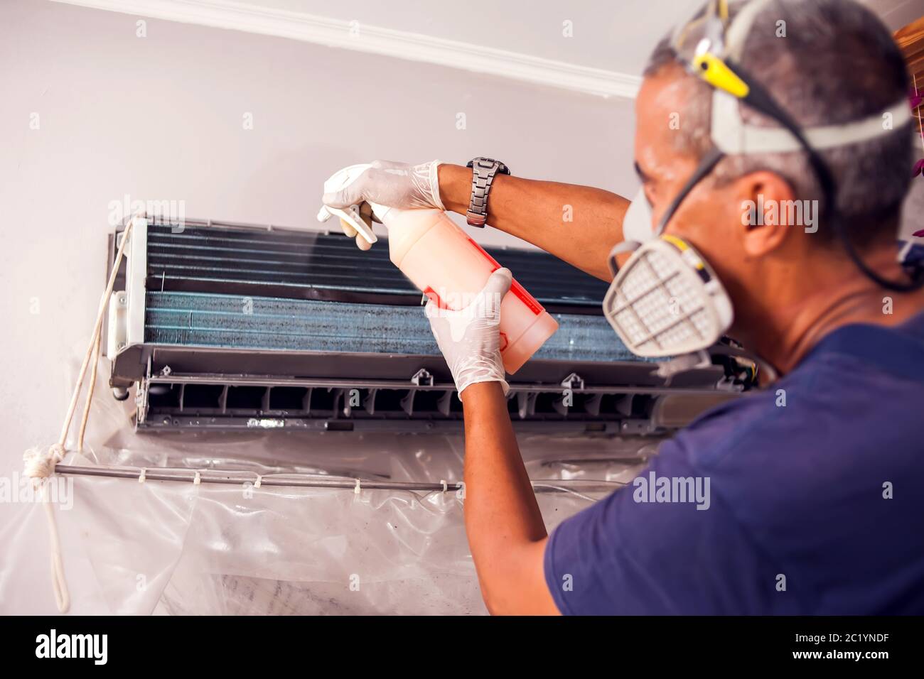 Man worker doing professional cleaning of air conditioning Stock Photo ...