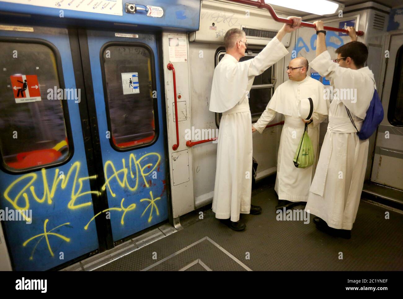 priests take the train from the city of Rome to the Vatican in Italy ...