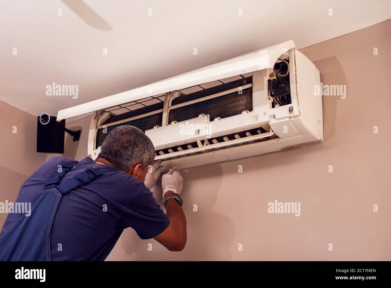 Man worker doing professional cleaning of air conditioning Stock Photo ...