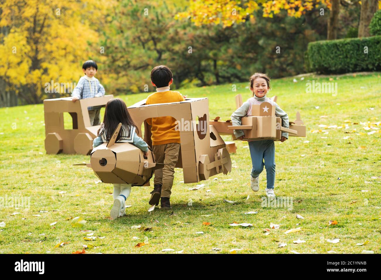 Happy children's play to fly Stock Photo - Alamy