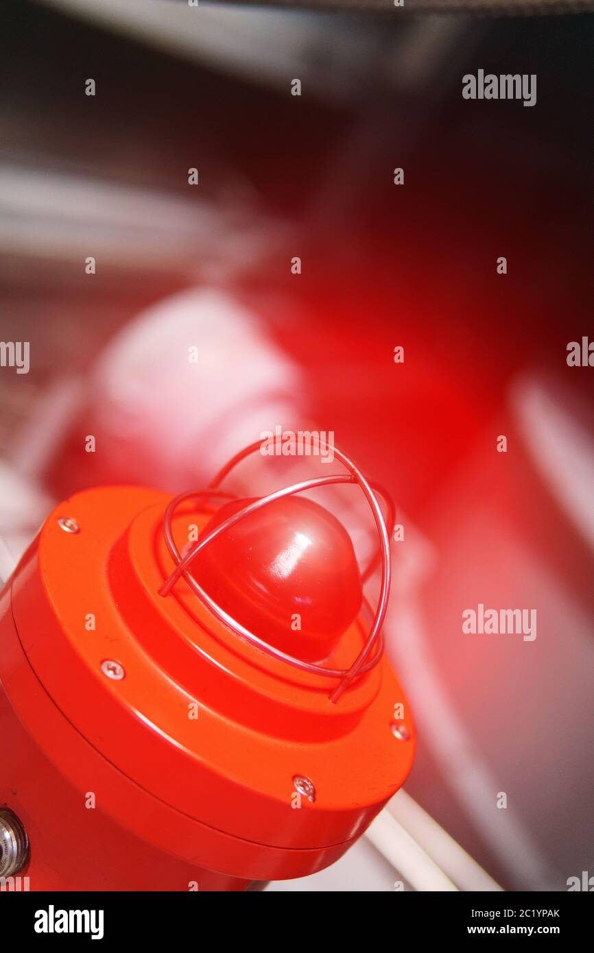 Red warning light of an emergency beacon at an industrial facility ...