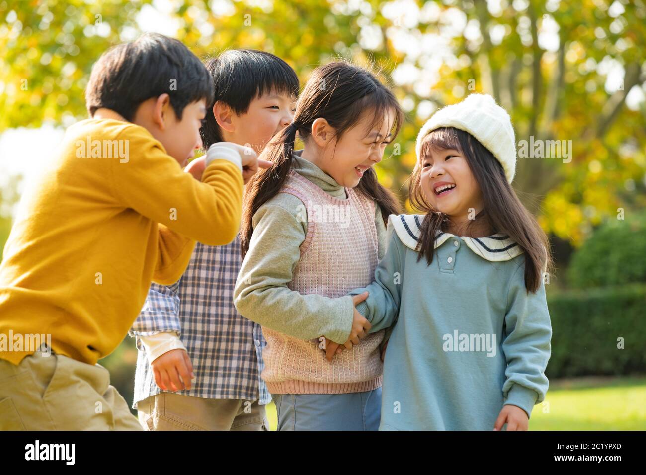 The four friends play in the park Stock Photo - Alamy