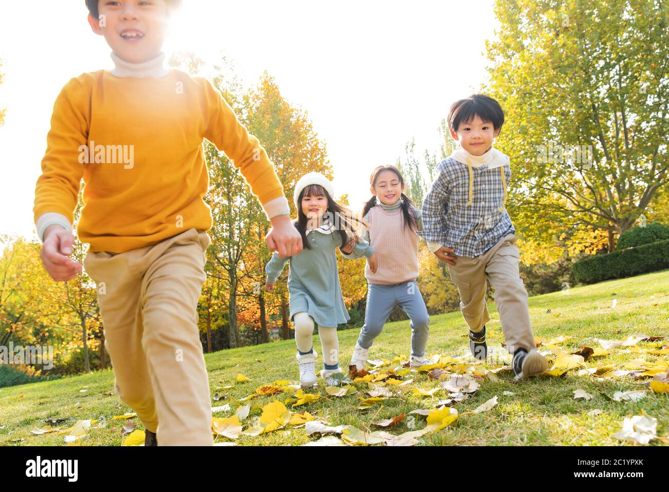 Happy children run to play in the park Stock Photo - Alamy