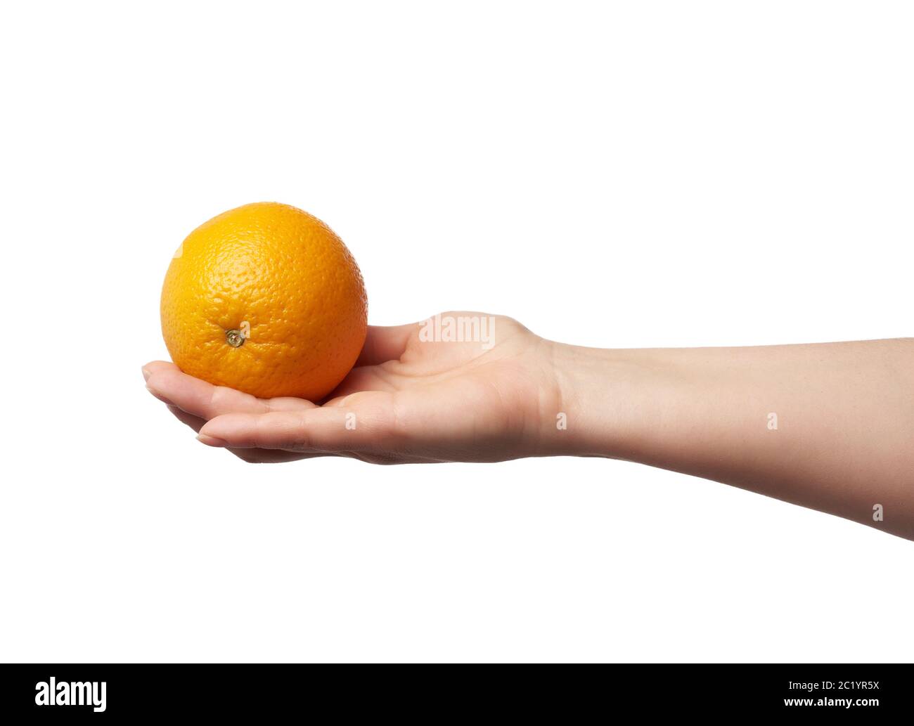 female hand holds a ripe orange, part of the body is isolated on a ...