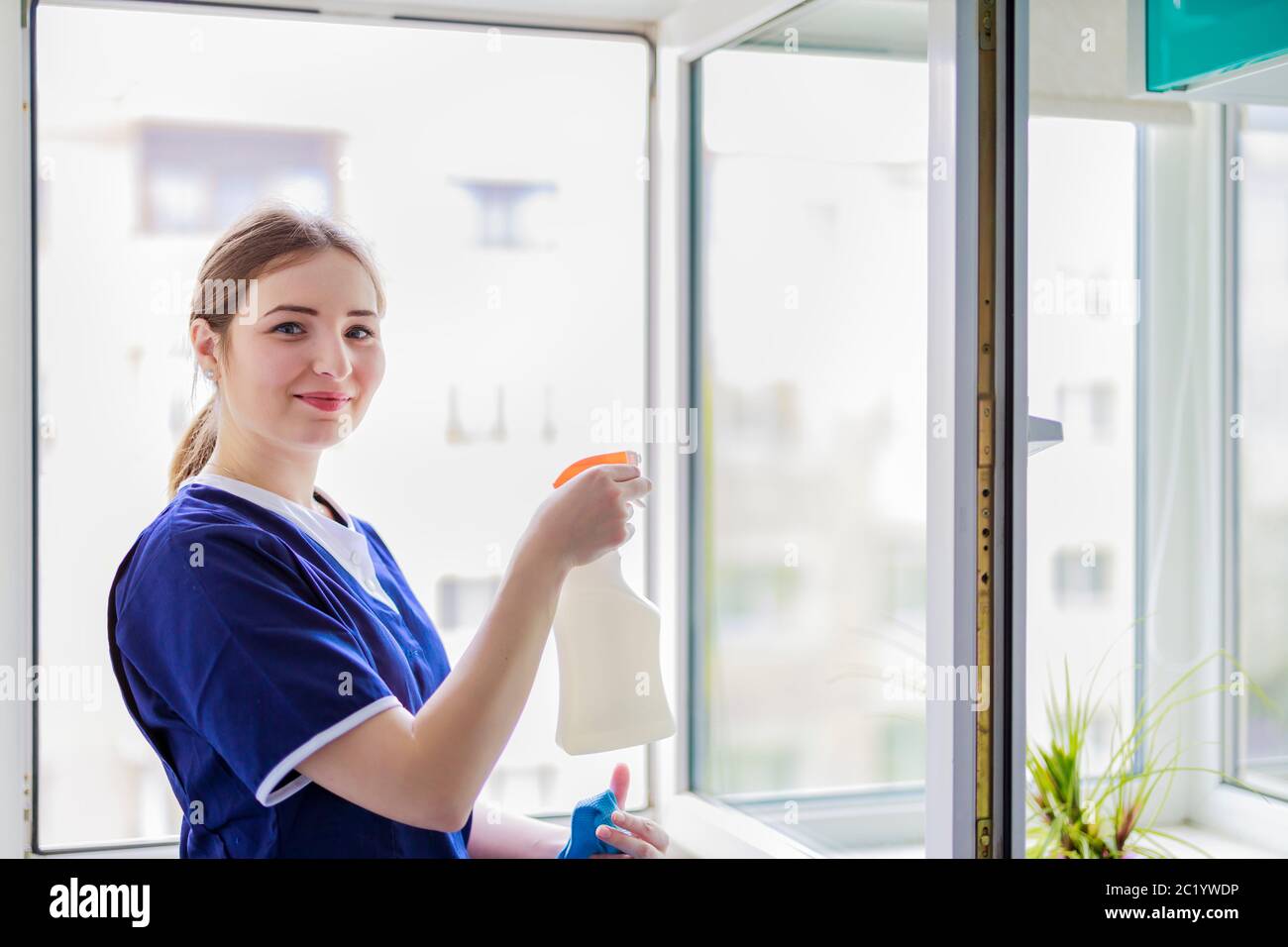 Attractive Woman Washing the Window with spray and rag Stock Photo - Alamy