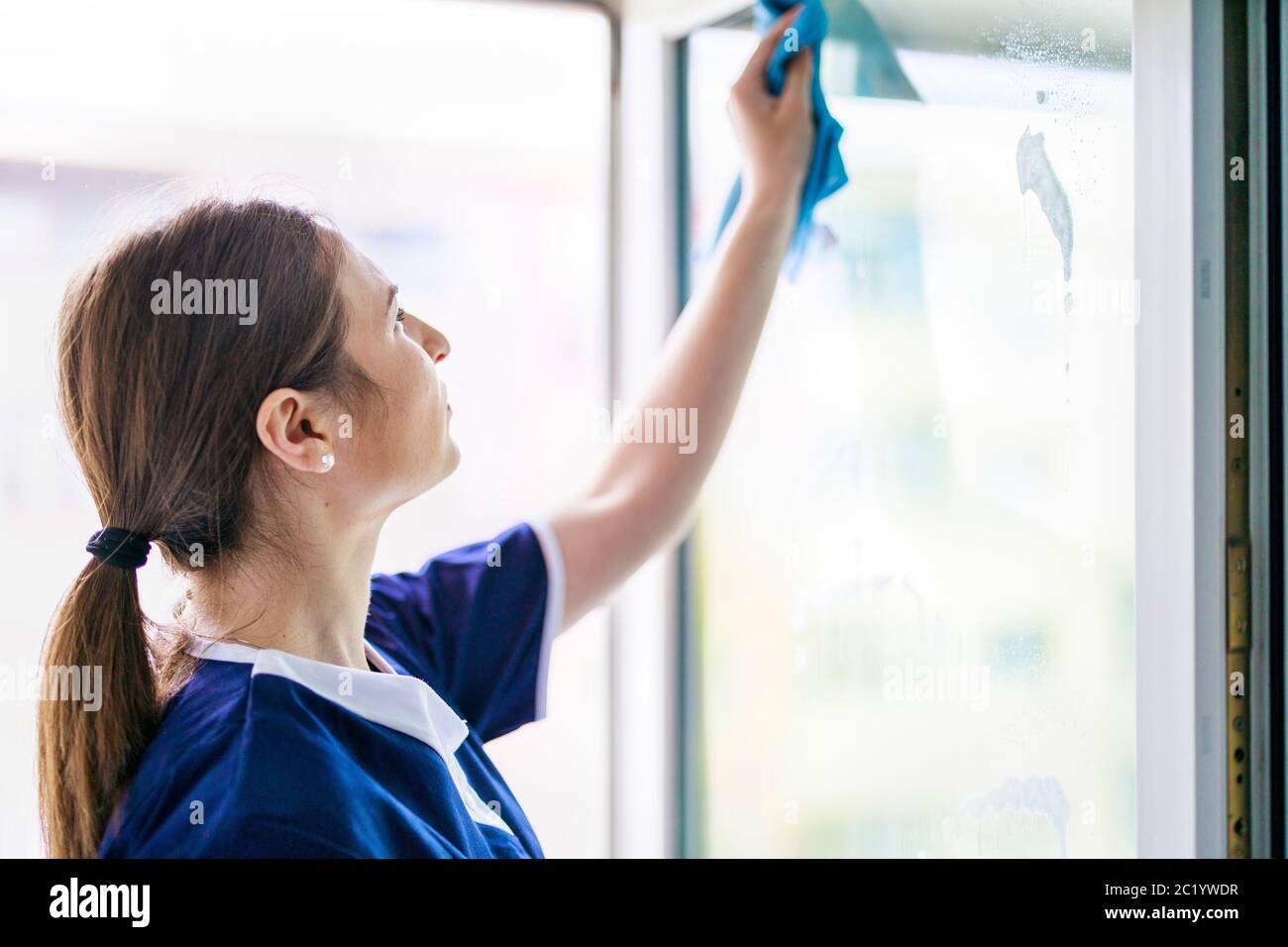 Attractive Woman Washing the Window with spray and rag Stock Photo - Alamy
