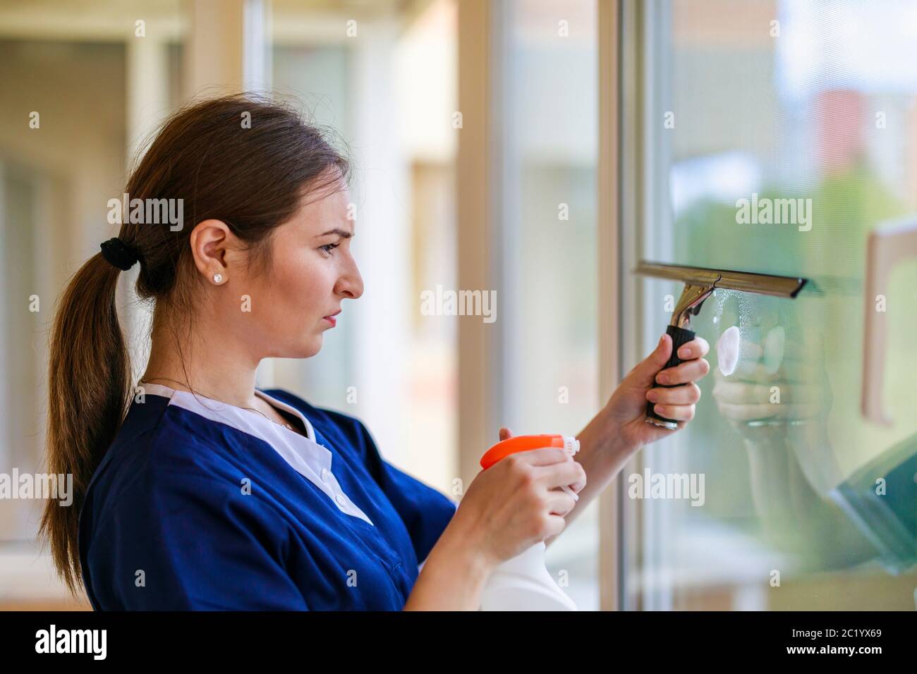 Attractive woman washing window hi-res stock photography and images - Alamy