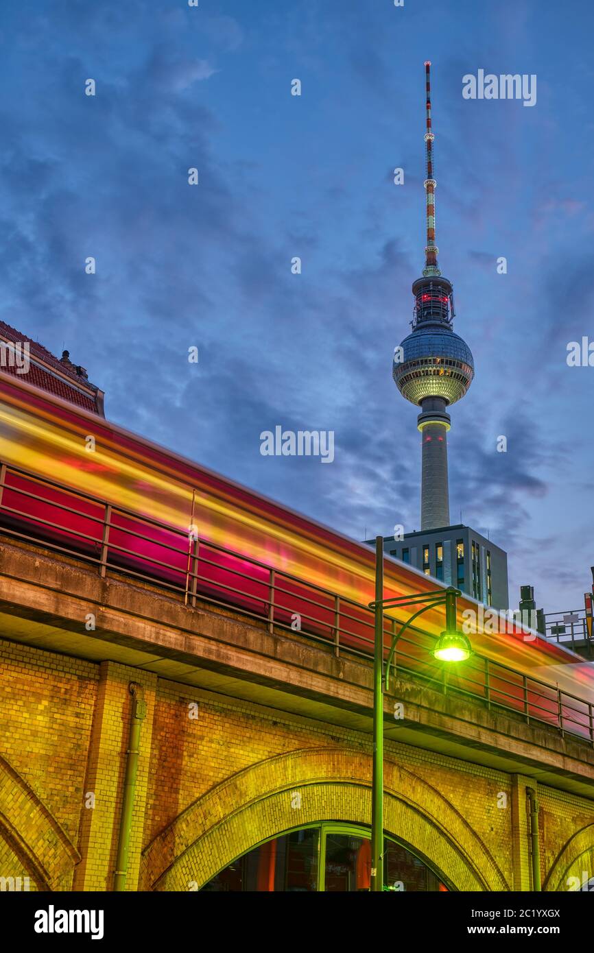 The famous Television Tower in Berlin at dusk with a motion blurred commuter train Stock Photo ...