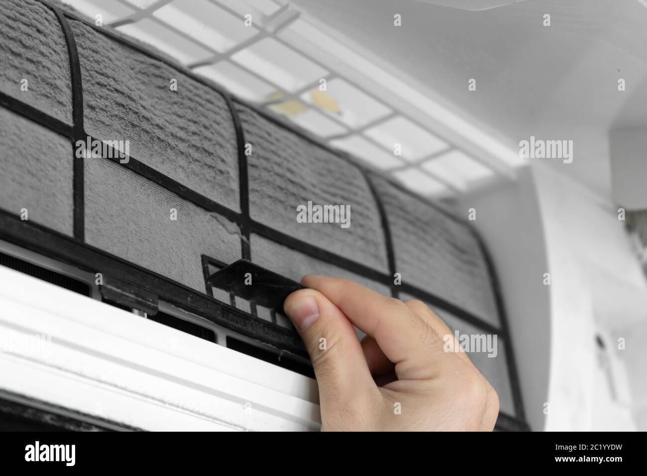 The guy cleans the filter of the home air conditioner from dust. Very ...