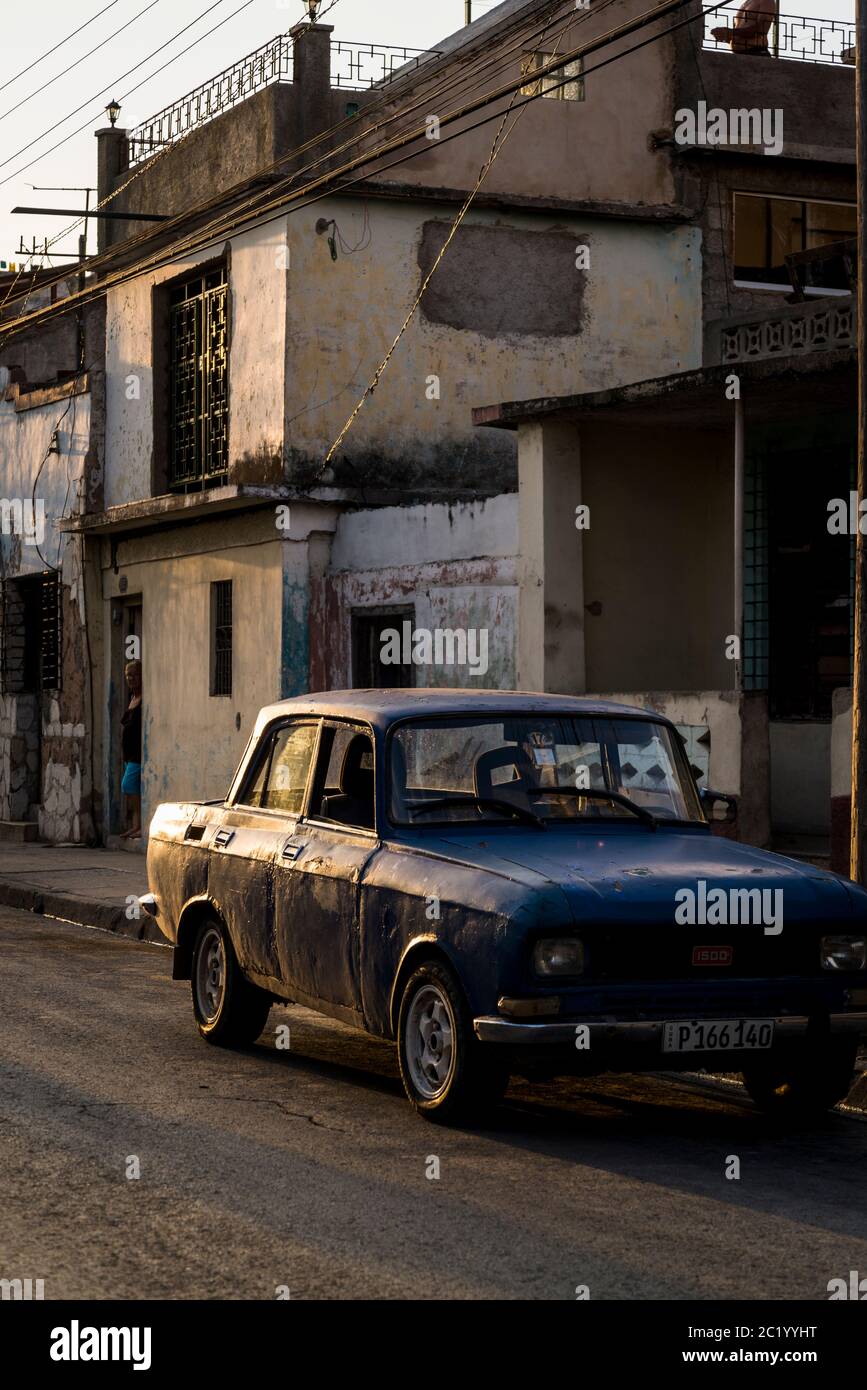 Old battered car parked in a poor residential neighbourhood, Santiago ...