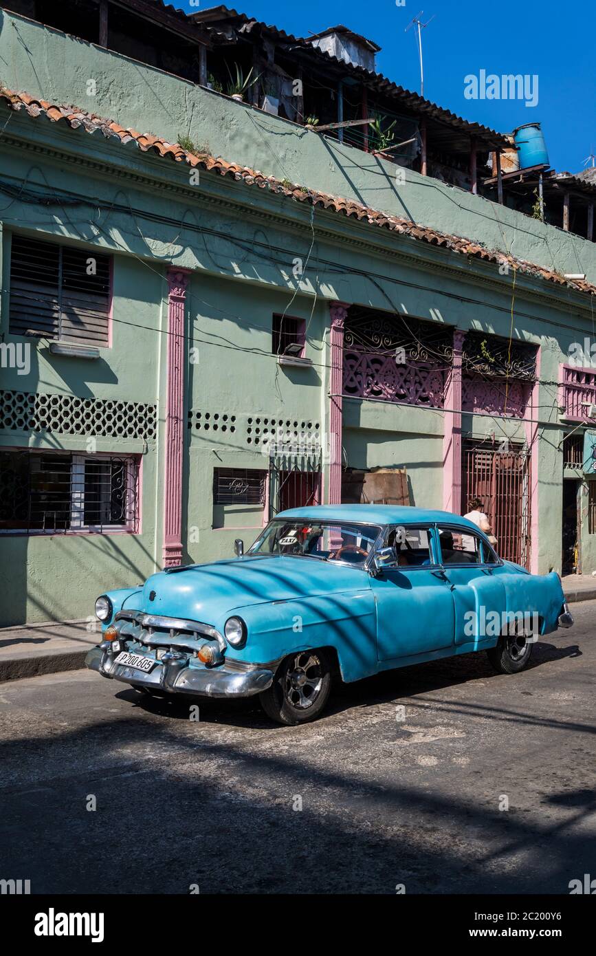 Classic car driving in Havana Centro, a working class neighbourhood ...