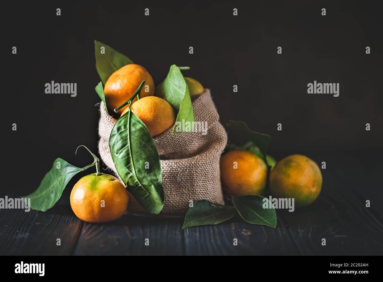 Tangerines with leaves on an old fashioned country table. Selective ...
