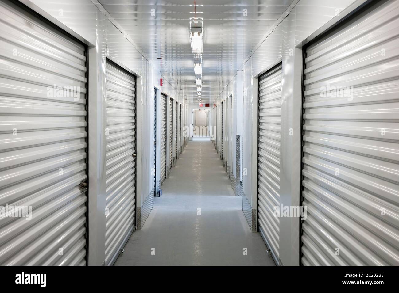 A perspective view down a corridor of storage units Stock Photo - Alamy