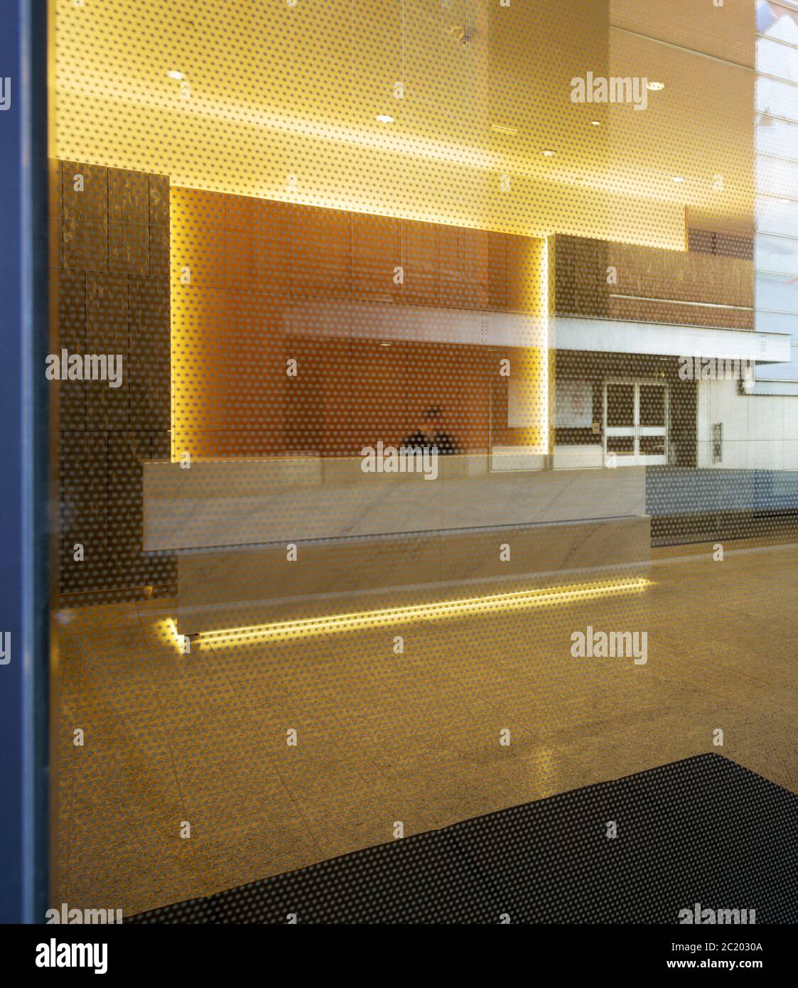 View of an office building reception area through a glass curtain wall ...