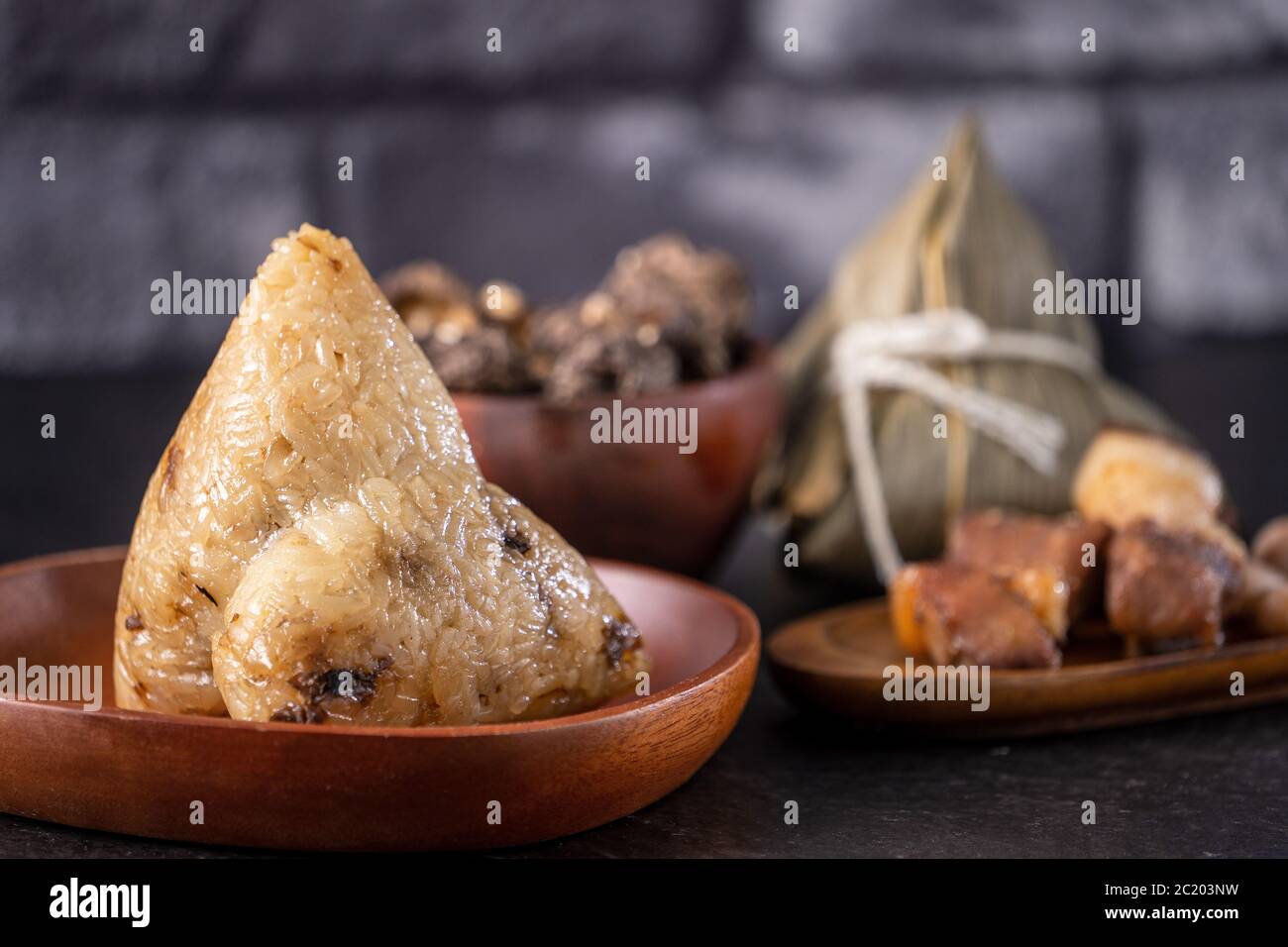 Rice dumpling, zongzi - Chinese rice dumpling zongzi on black brick ...