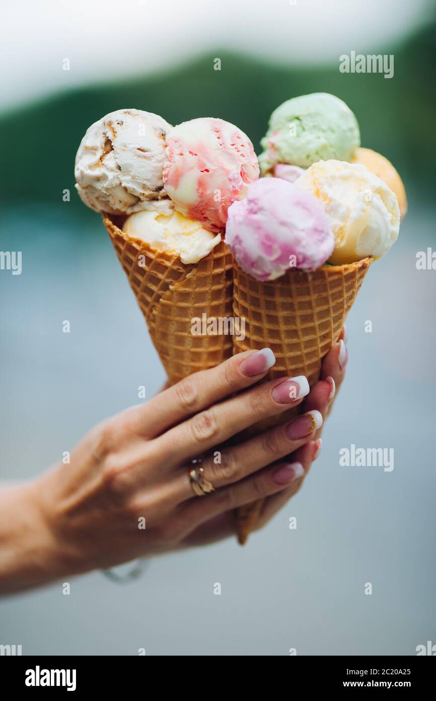 Crop of woman's hand holding delicious colorful ice cream Stock Photo ...