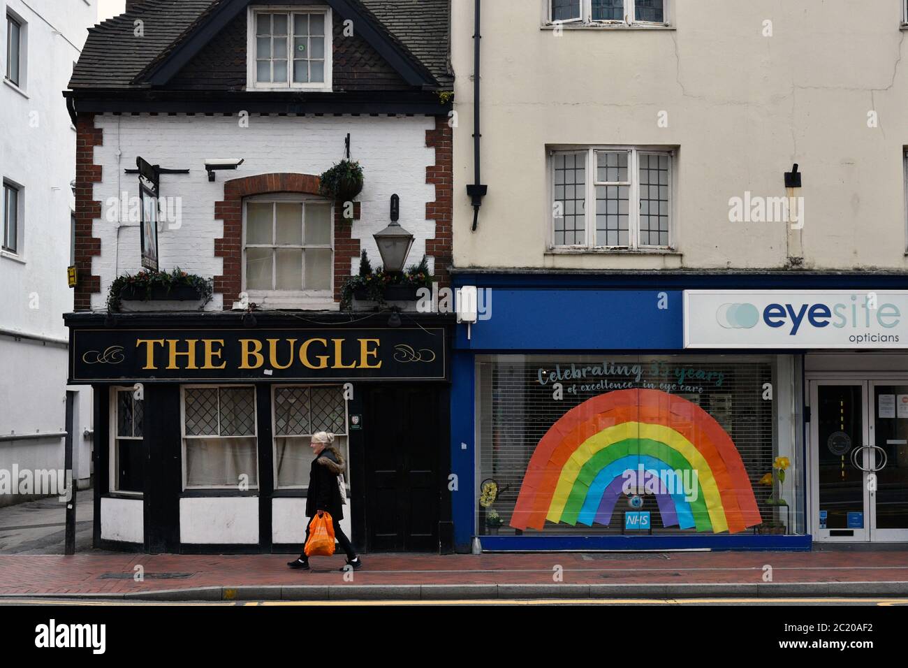 Signage celebrating the NHS in a shop window next to a closed pub ...