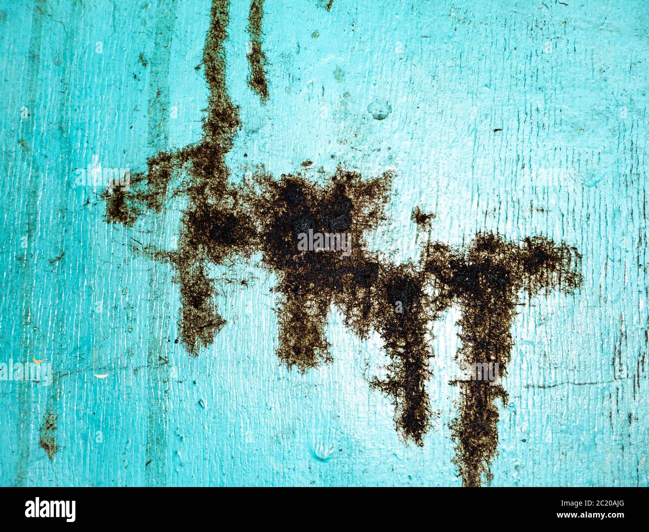 Drips of black paint on a blue wall texture Stock Photo - Alamy