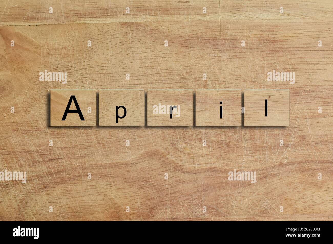 April word written on wood block. Message text on wooden table for ...